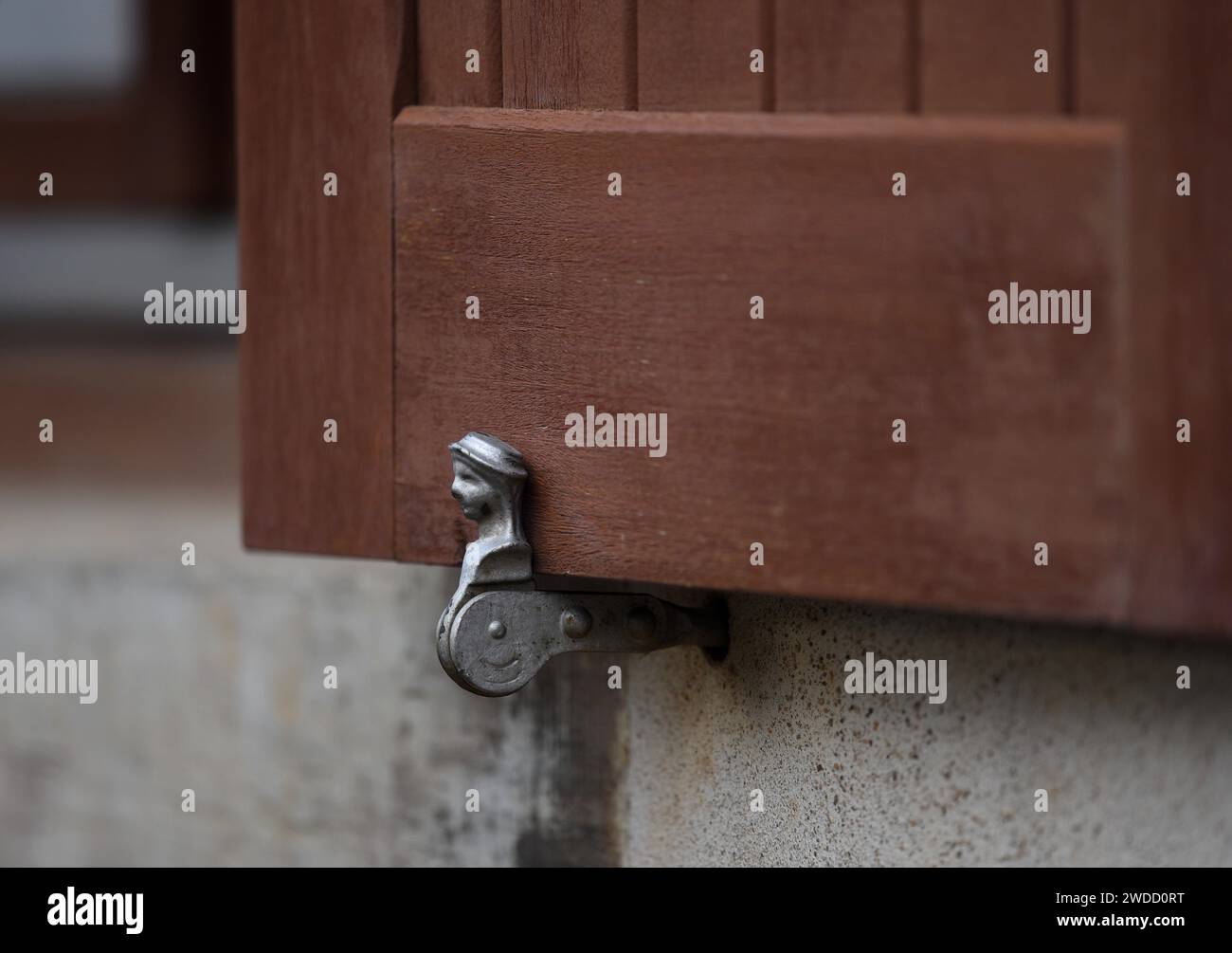 Rural house wooden window shutter with a pewter miniature coal miner ...