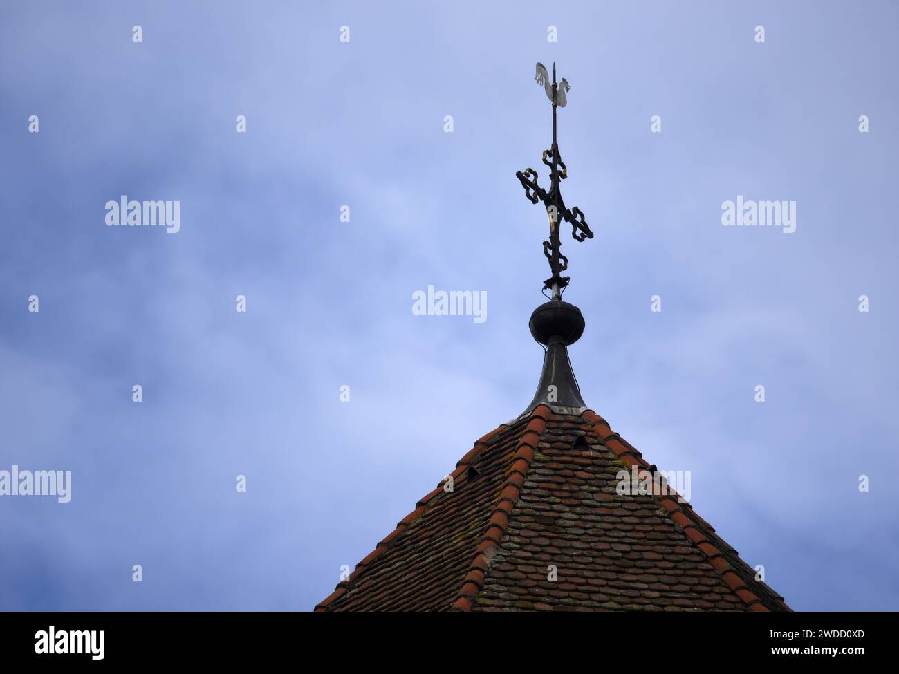 Antique wind cardinal direction compass on a clay tile rooftop in ...