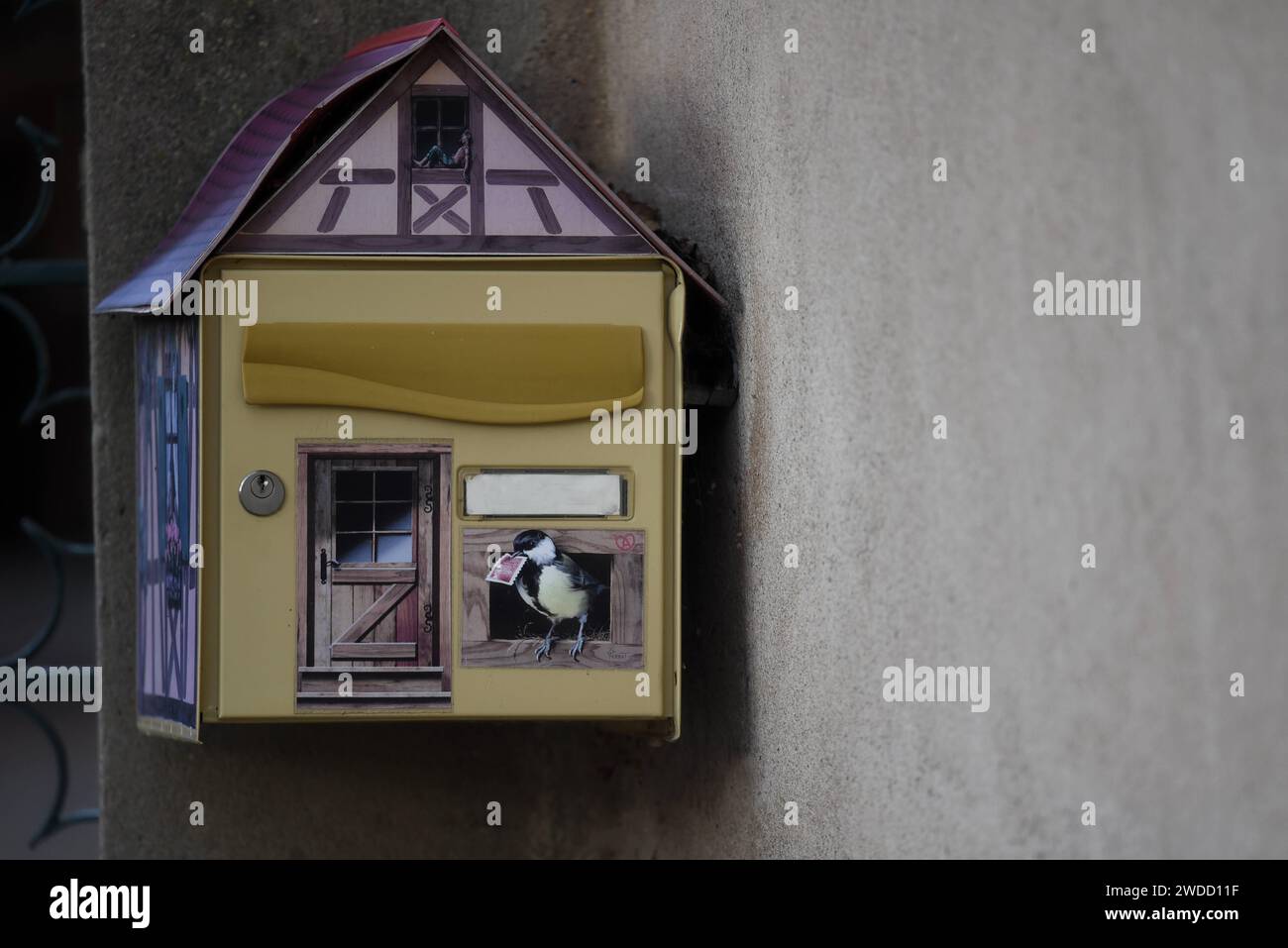 Picturesque mailbox on the exterior wall of a rural house in Gertwiller ...