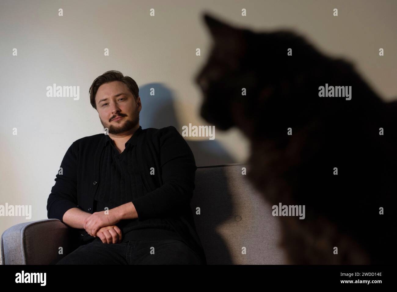 Ashton Colby is photographed with his cat Teddy in his apartment in ...