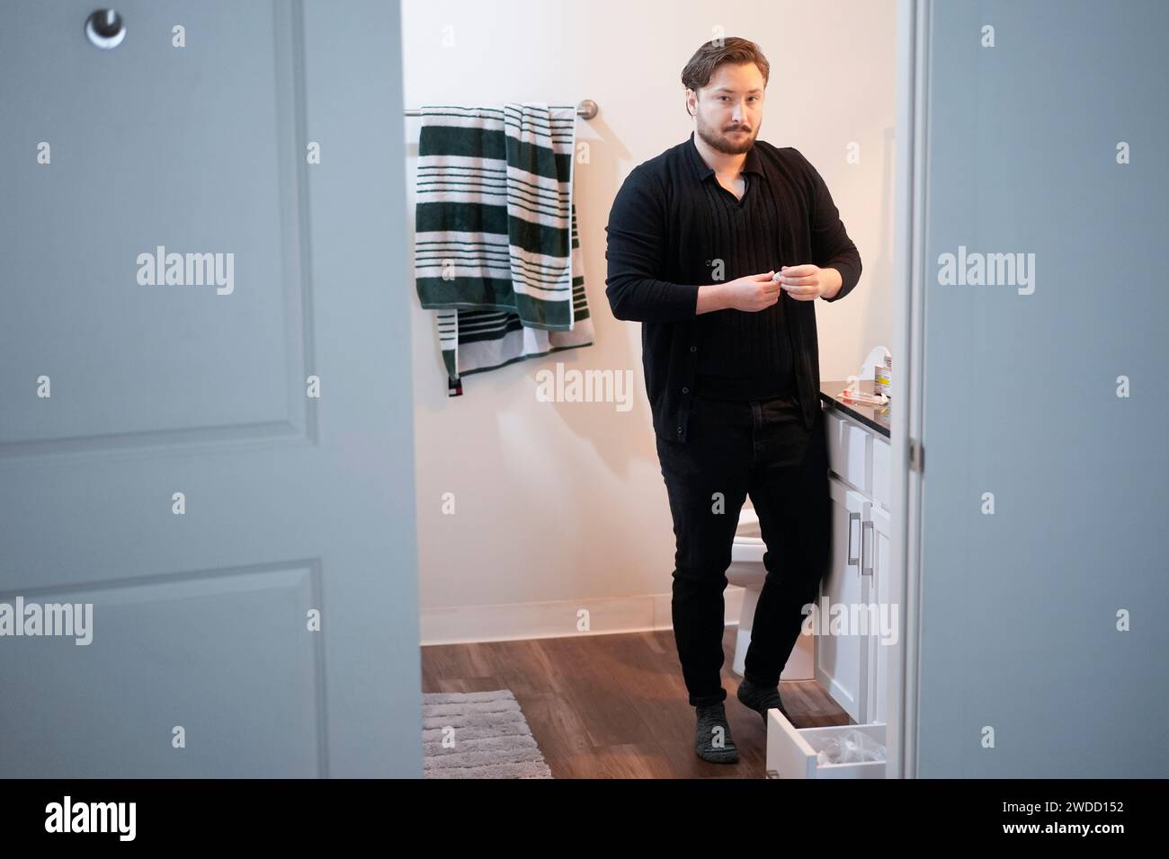Ashton Colby holds a vial of Testosterone Cypionate Injection in his ...