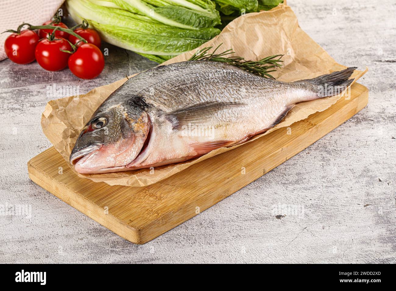Raw dorada fish served rosemary for cooking Stock Photo - Alamy