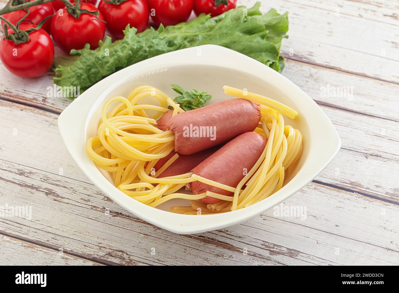 Mini sausages with pasta spaghetti for kids Stock Photo - Alamy