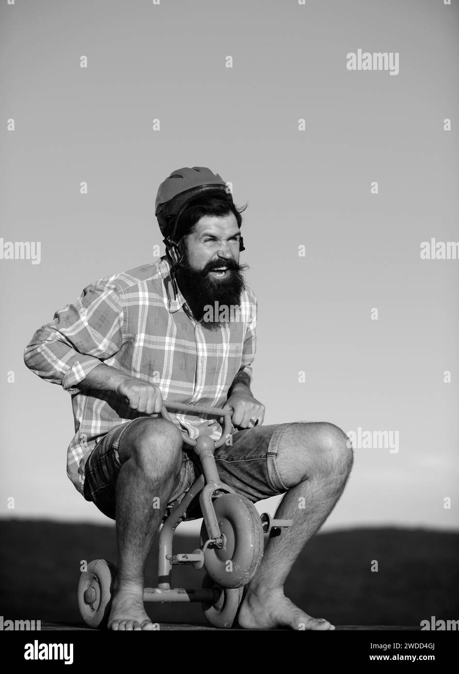 Nerdy hipster guy riding a small bicycle. Funny rider. Comic man ride ...