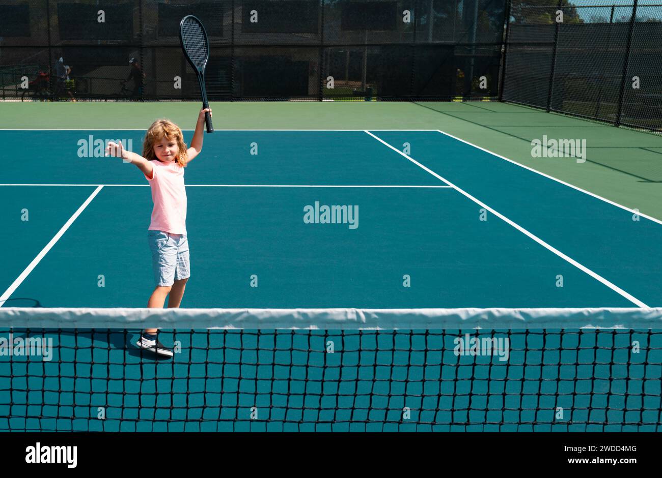 Child boy tennis player on tennis court Stock Photo - Alamy