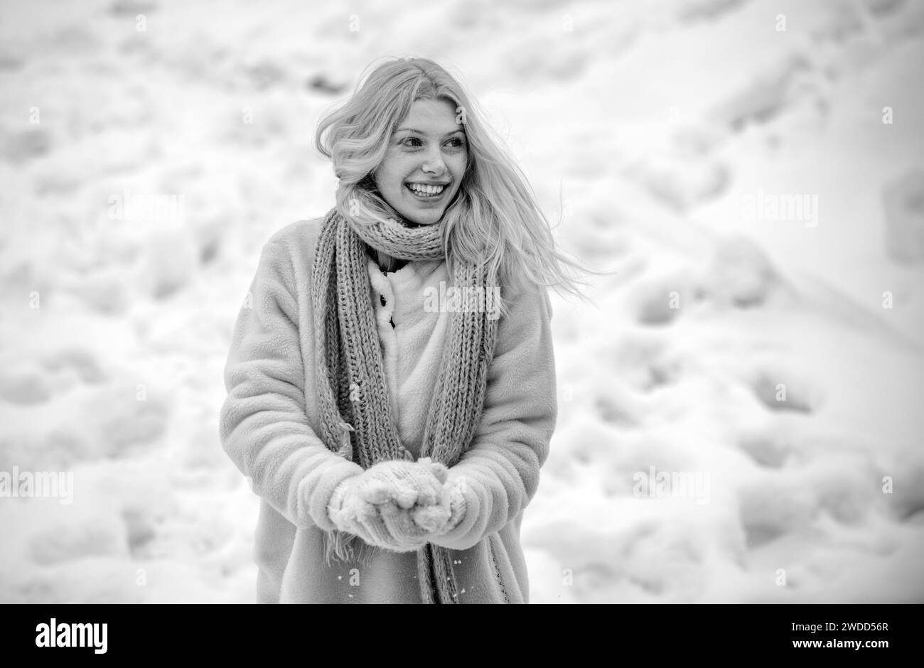 Girl playing with snow throwing a ball in winter holidays. Happy woman ...