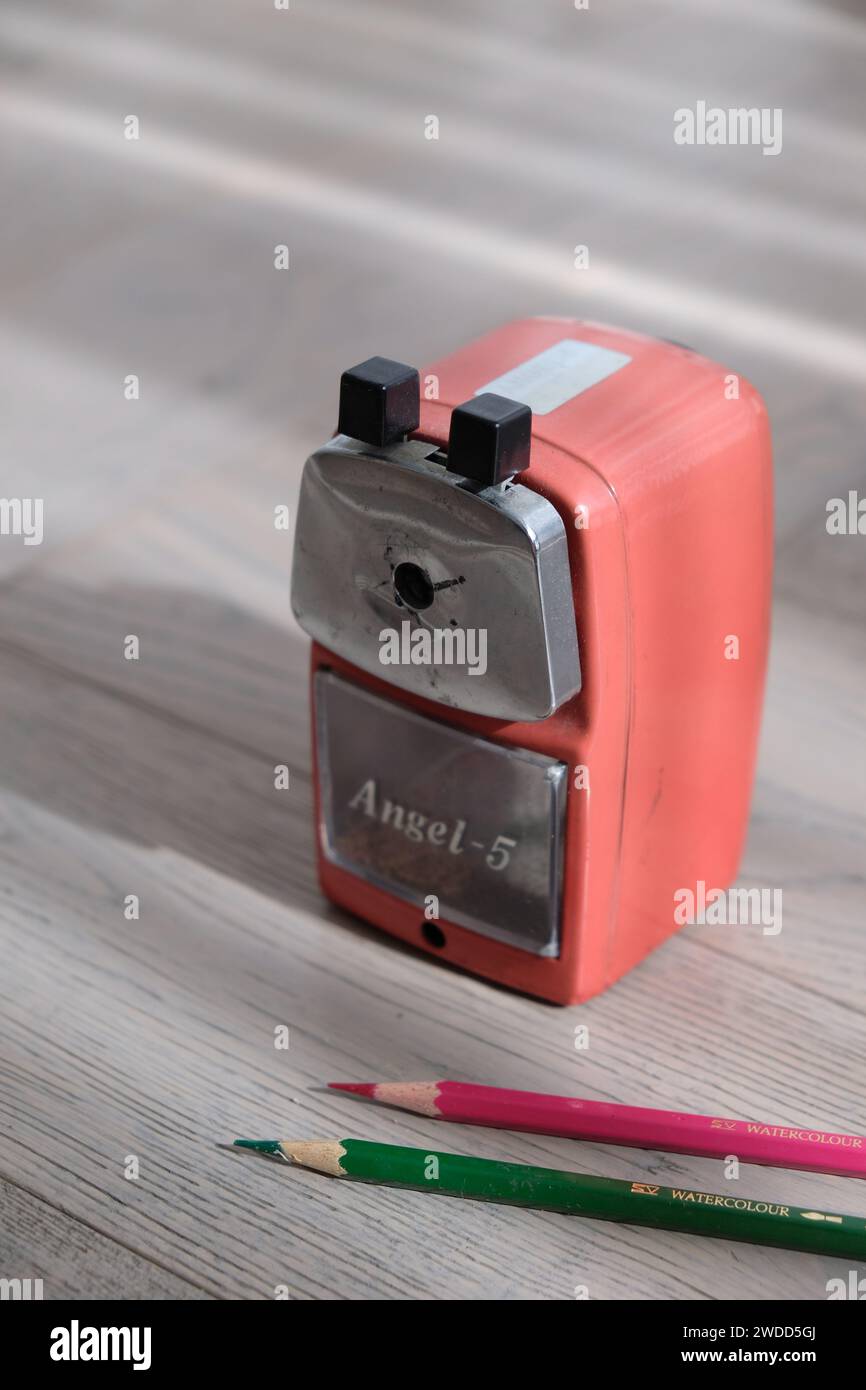 a red pencil sharpener with timber background Stock Photo - Alamy