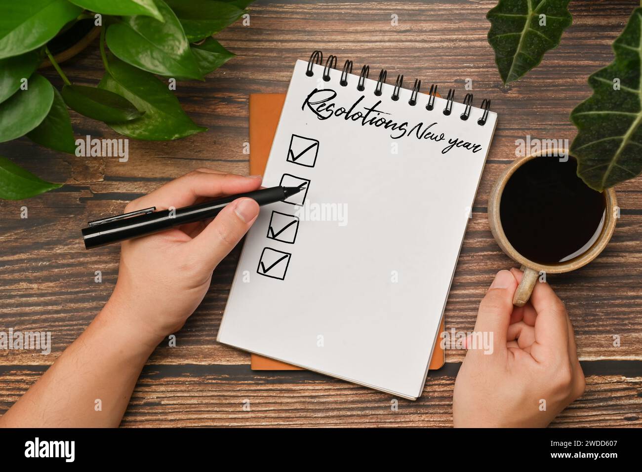 Woman hand writing resolution list on notebook. Self improvement and ...