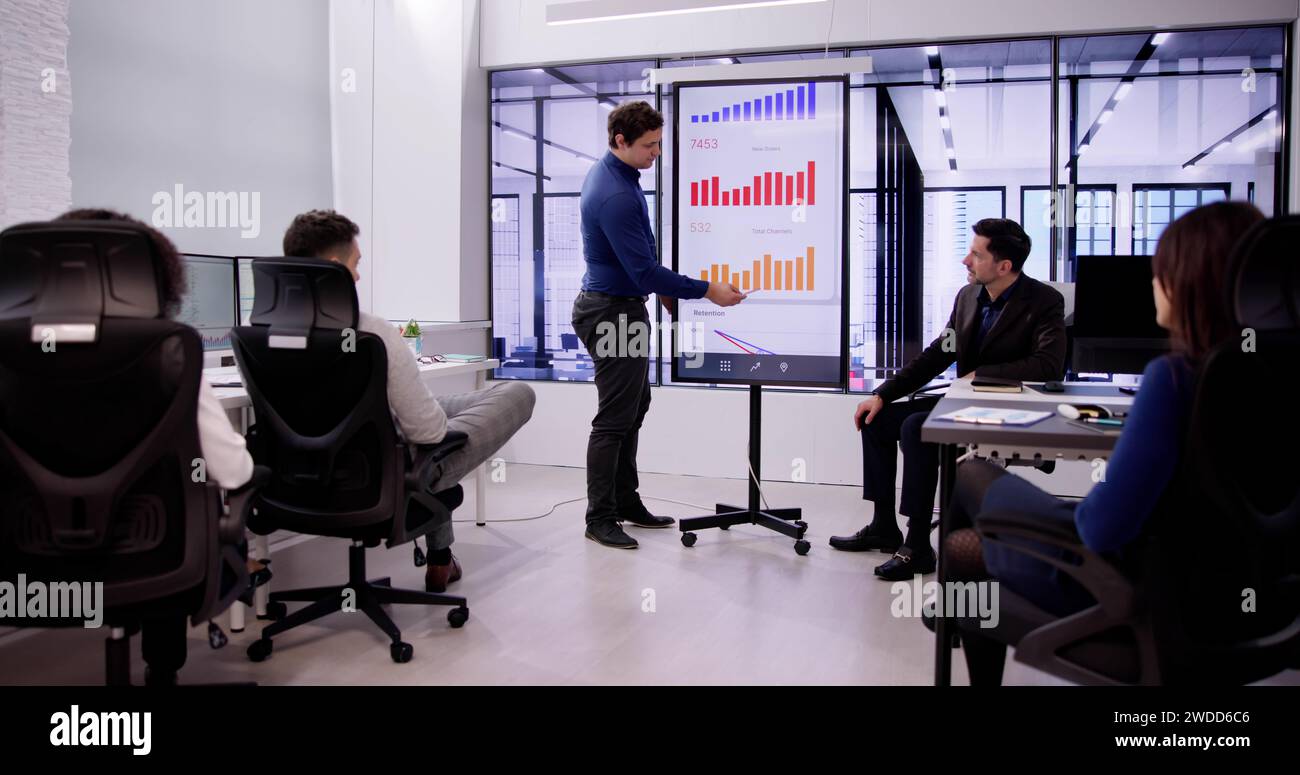 Diverse Team Meeting With TV Screen. Presenter With Dashboard Stock ...