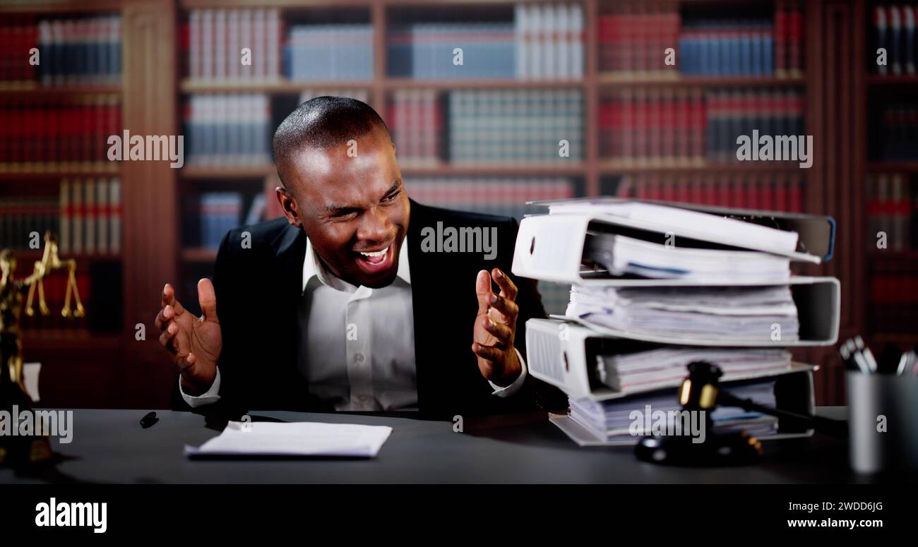 Young Stressed Male Lawyer Working With Stacked Folders Stock Photo - Alamy