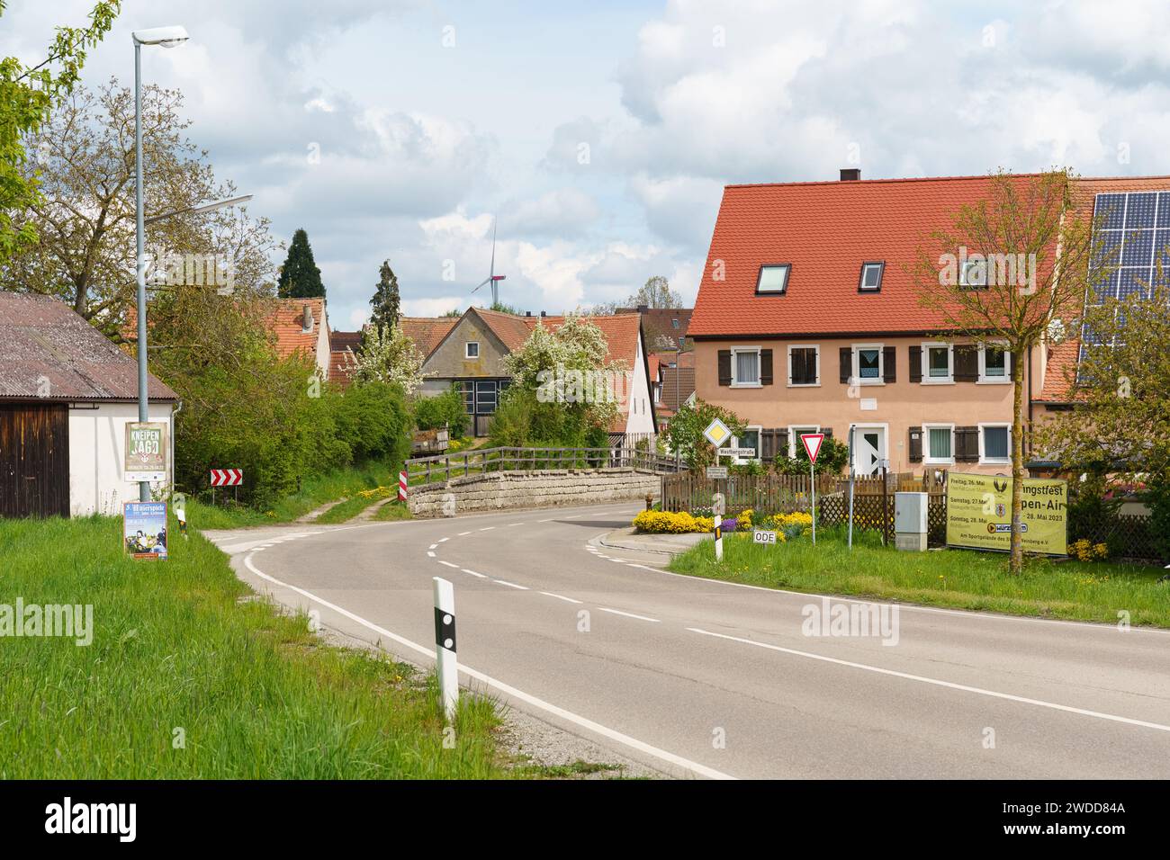 Weinberg, Germany - May 6, 2023: Houses along the road, cars in a ...