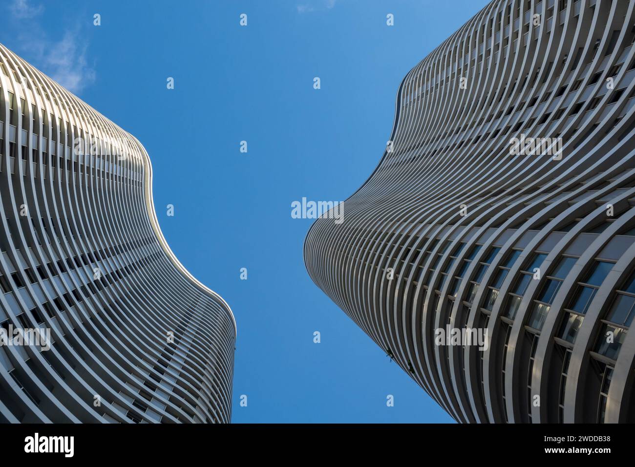 Curvilinear modern skyscrapers soar against a clear blue sky ...