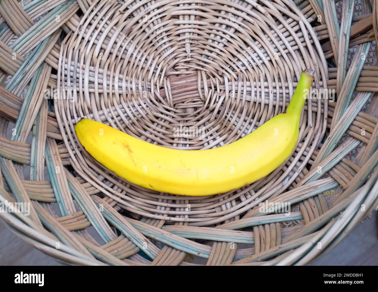 Yellow banana inside a wicker basket Stock Photo - Alamy