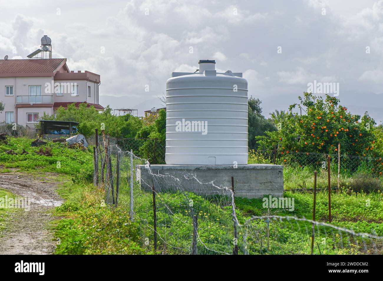 water container in a village courtyard on the island of Cyprus Stock ...