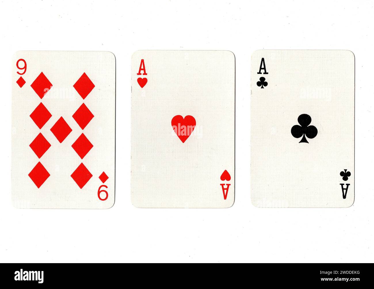 Vintage playing cards showing a pair of aces and a red nine isolated on ...