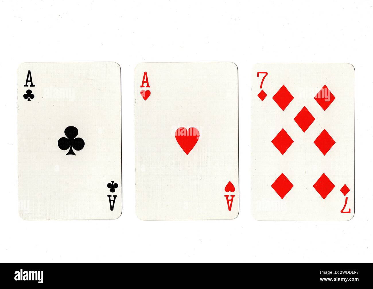 Vintage playing cards showing a pair of aces and a red seven isolated ...