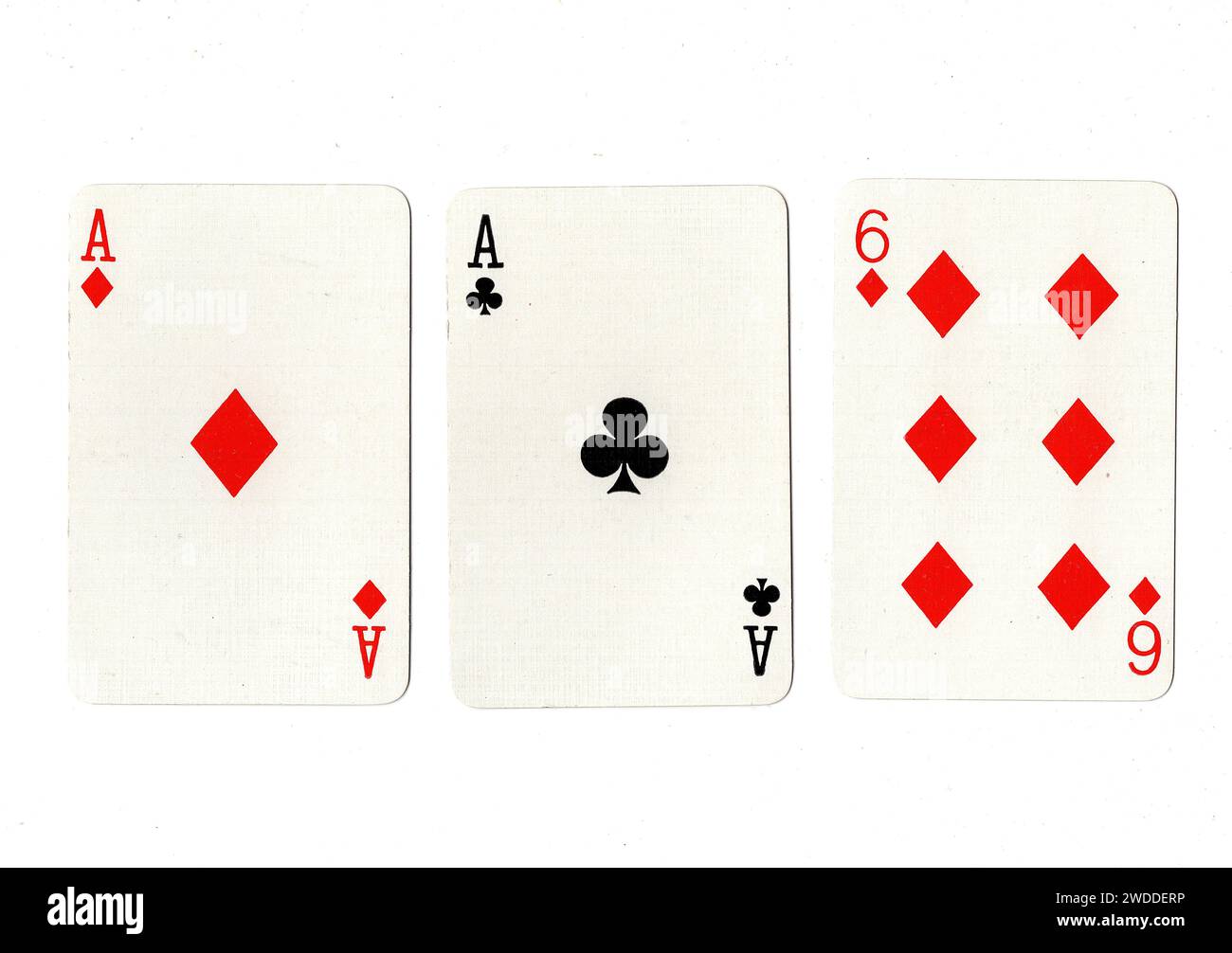 Vintage playing cards showing a pair of aces and a red six isolated on ...