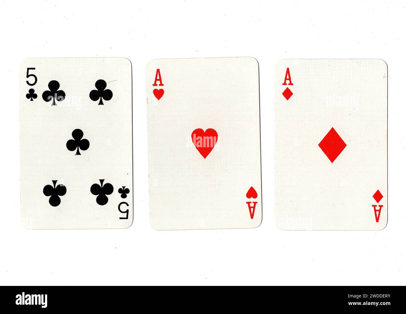 Vintage playing cards showing a pair of red aces and a black five ...