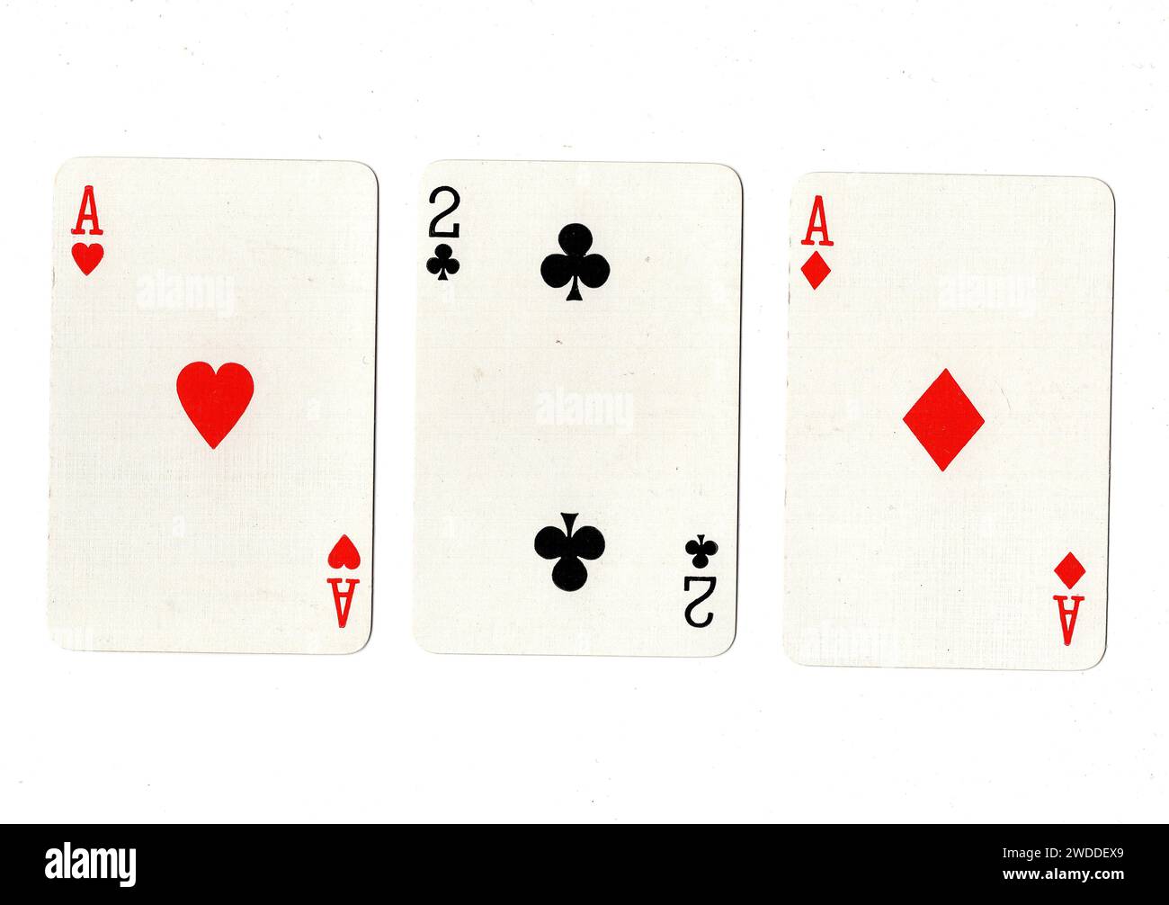 Vintage playing cards showing a pair of red aces and a black two ...