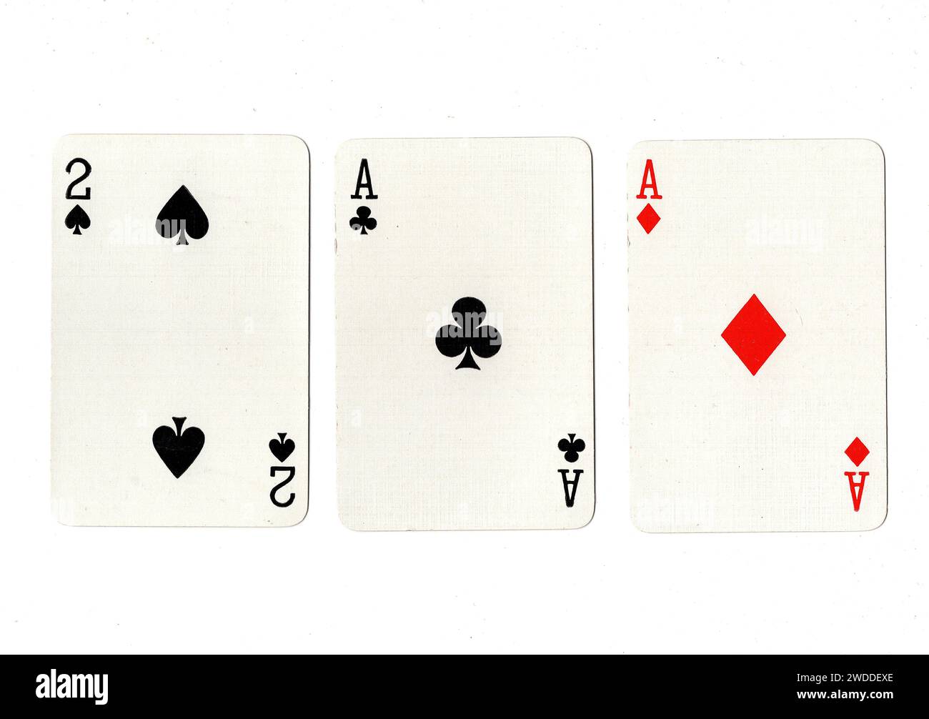 Vintage playing cards showing a pair of aces and a black two isolated ...