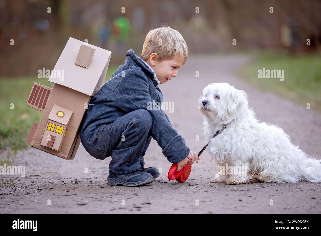 Little child, blond boy with pet dog, carying home on his back, kid ...