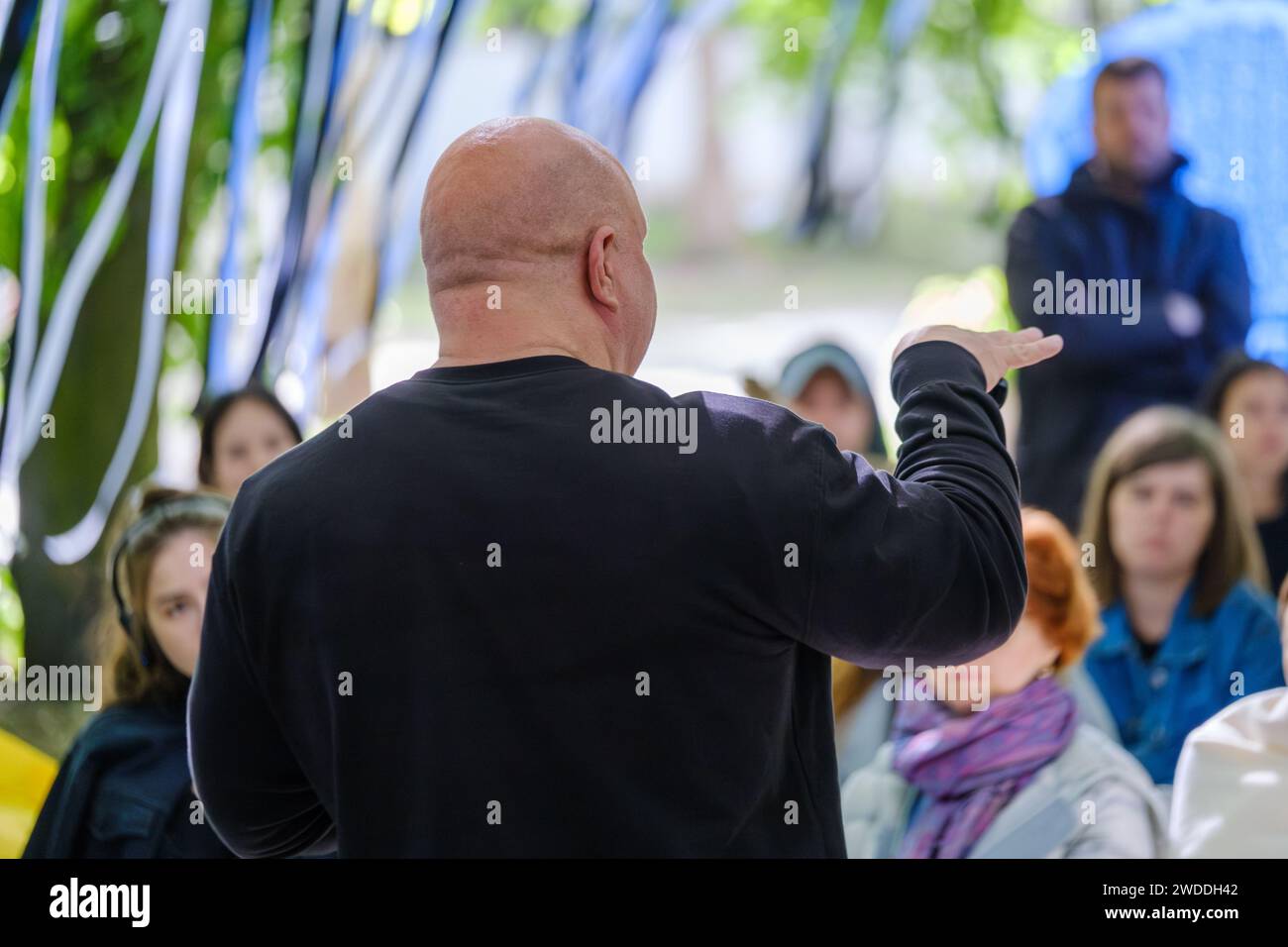 Engaging speaker delivering a speech to a diverse group of listeners at ...