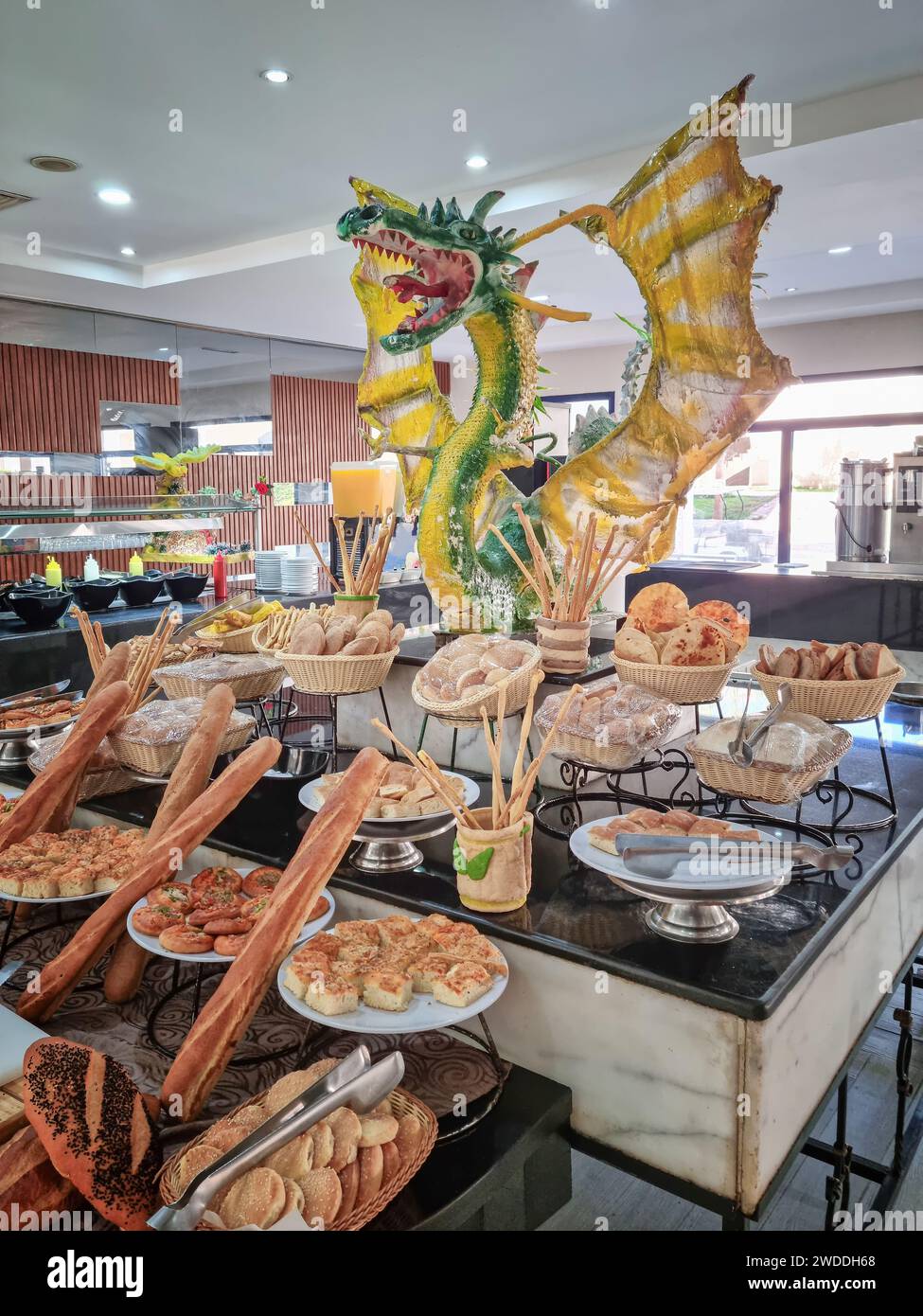 The buffet in the restaurant with a variety of dishes is decorated with ...