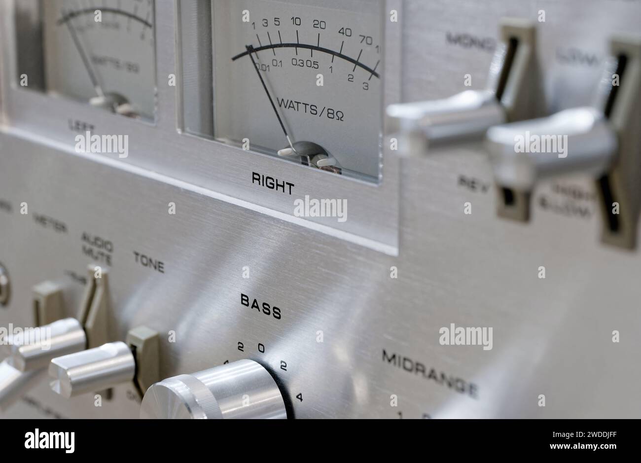 Old vintage stereo amplifier, aluminium front panel with knobs, buttons ...