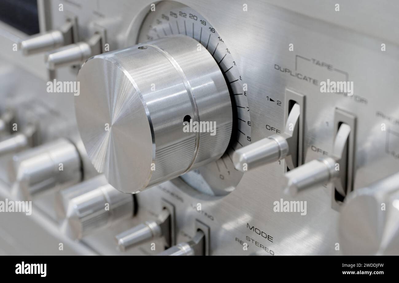 Old vintage stereo amplifier, aluminium front panel with knobs, buttons ...