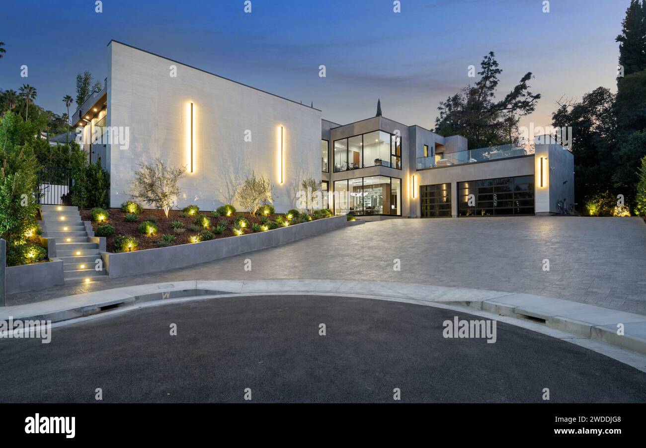 An Empty driveway leading to a white building with outdoor light, New ...