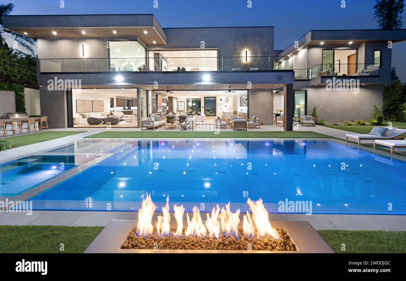 A Fire pit near a pool on the ground, New Construction Home in Tarzana ...