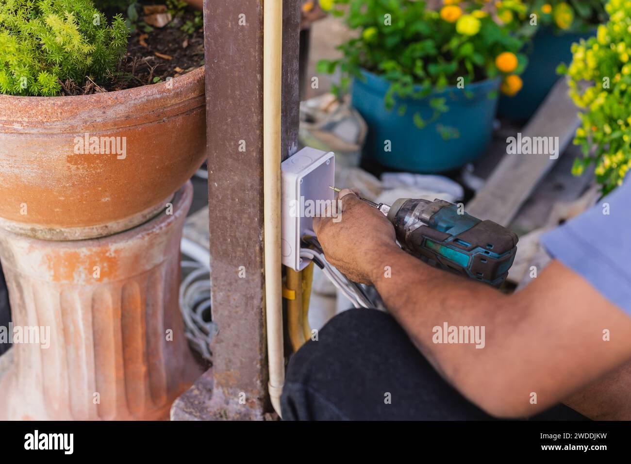 Electrician installing switches and sockets box on the metal pole Stock ...