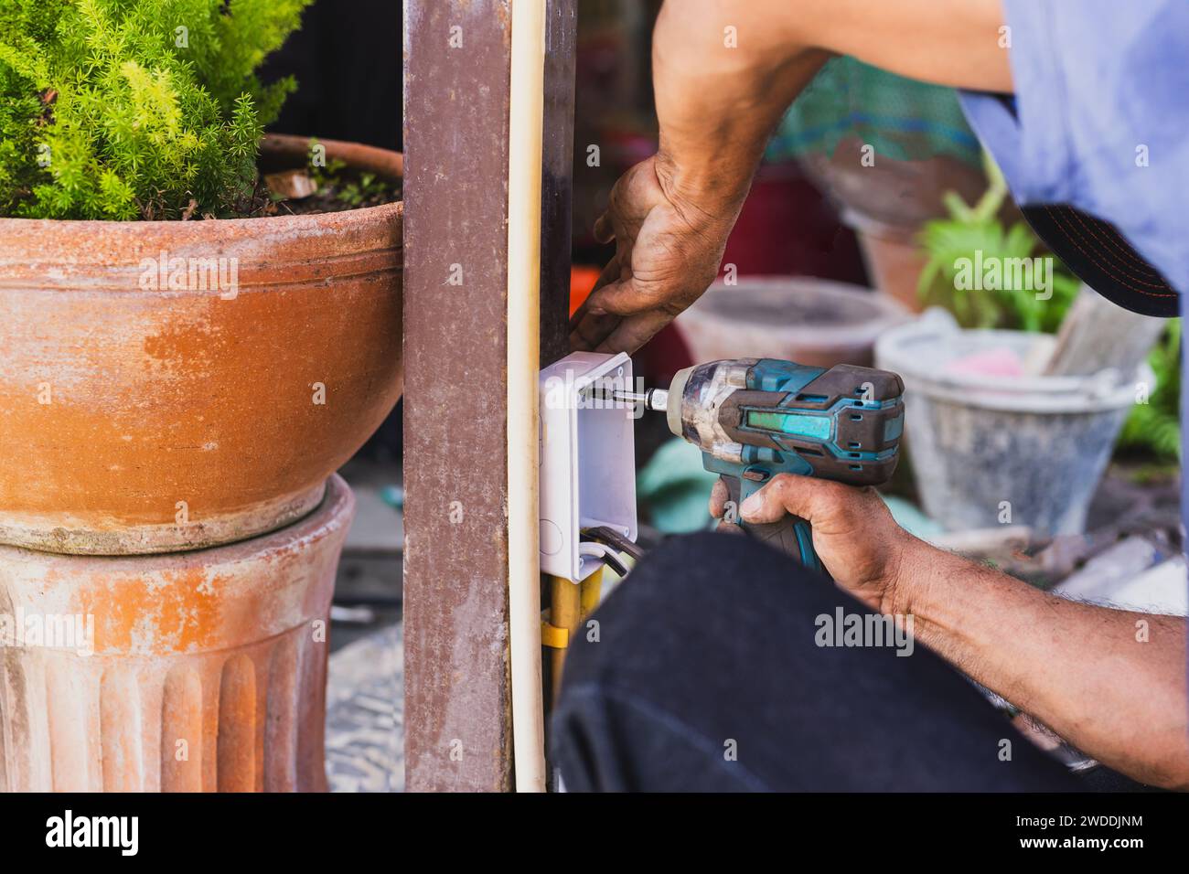 Electrician installing switches and sockets box on the metal pole Stock ...