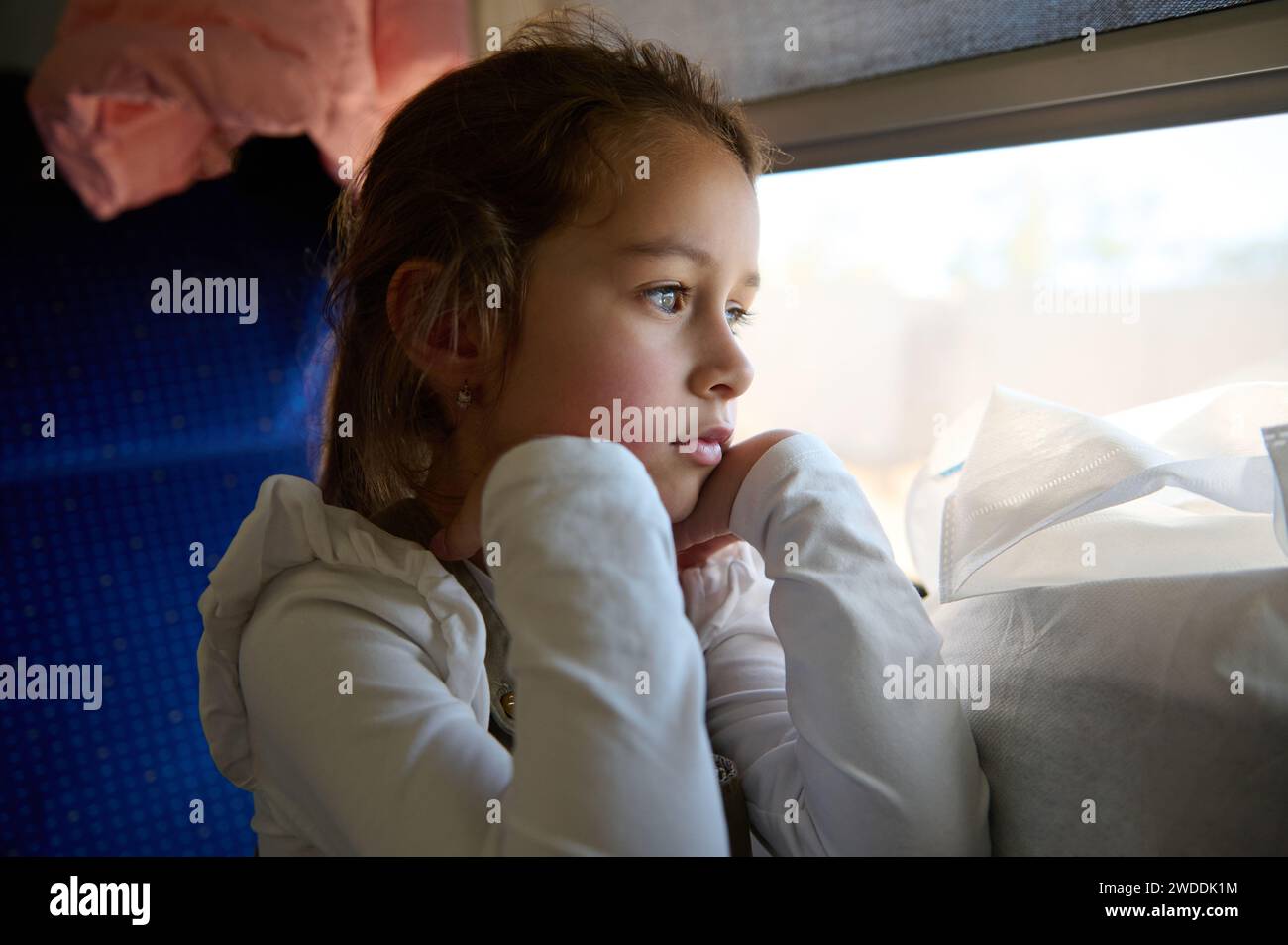 Close-up portrait of a Caucasian pensive beautiful little child girl ...