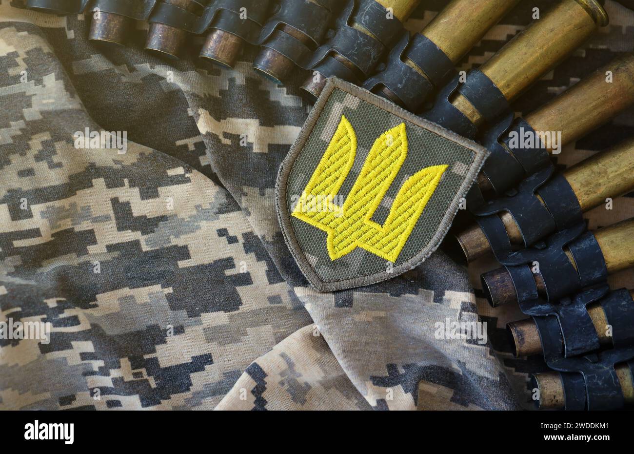 Ukrainian army symbol on machine gun belt lies on ukrainian pixeled ...