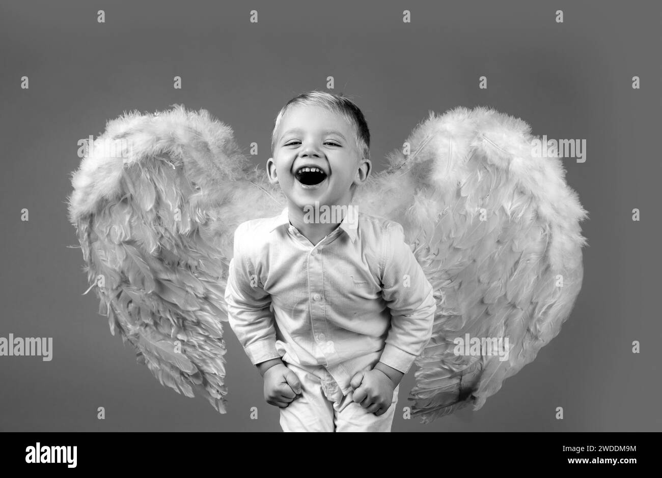 Excited funny angel children boy with white wings laughing. Valentines ...