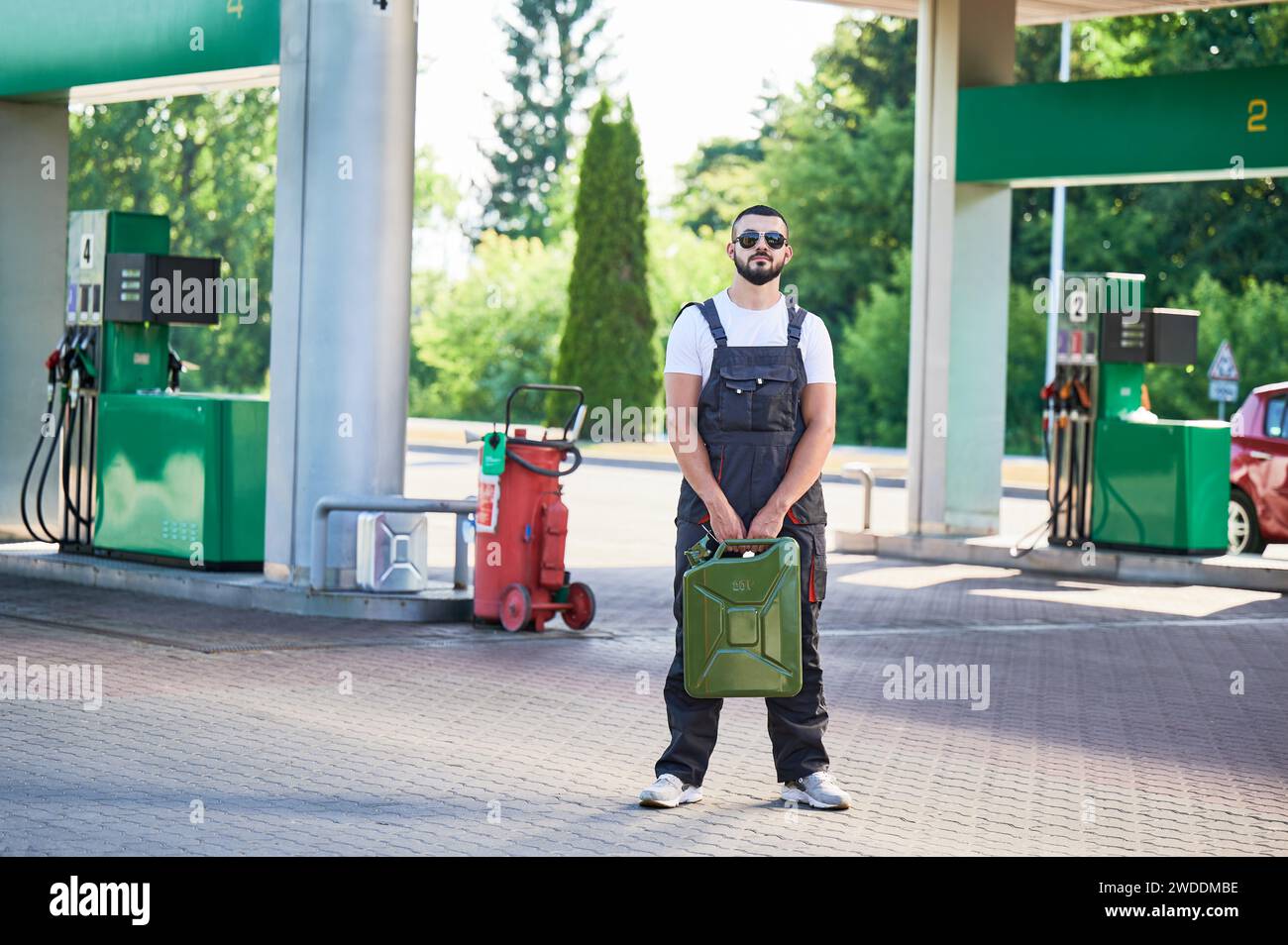 Professional worker holding canister in hands. Confident operator in ...