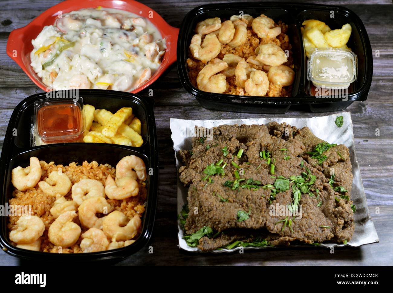 Background of fried shrimps on top of Sayadieh red rice, French fries ...