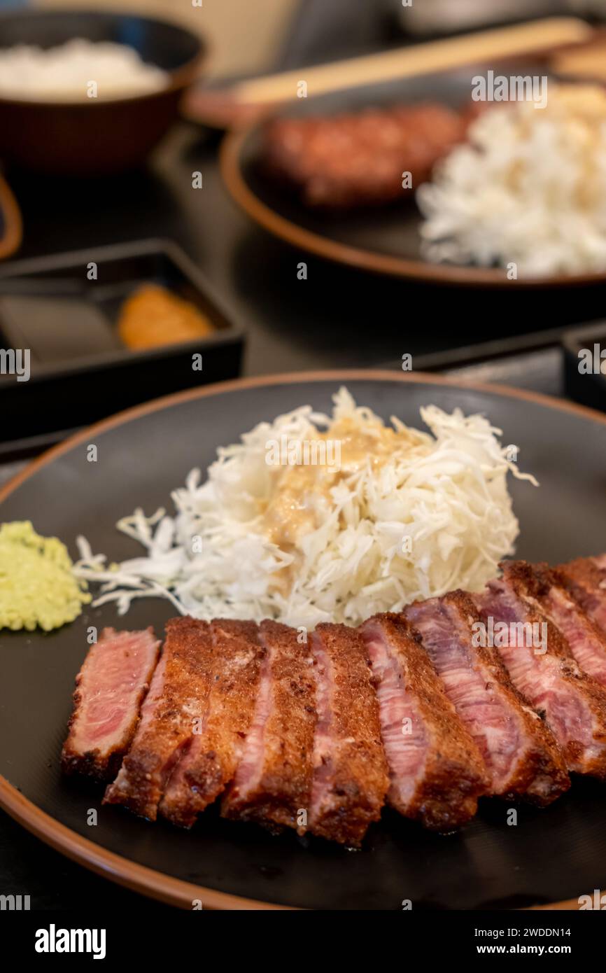 Set of Gyukatsu or beef cutlet served with cabbage. A traditional ...