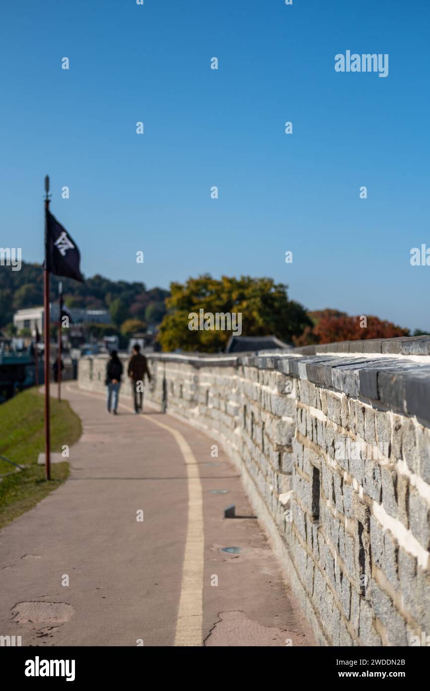 Suwon Hwaseong Fortress Wall, with the park view during autumn. The ...