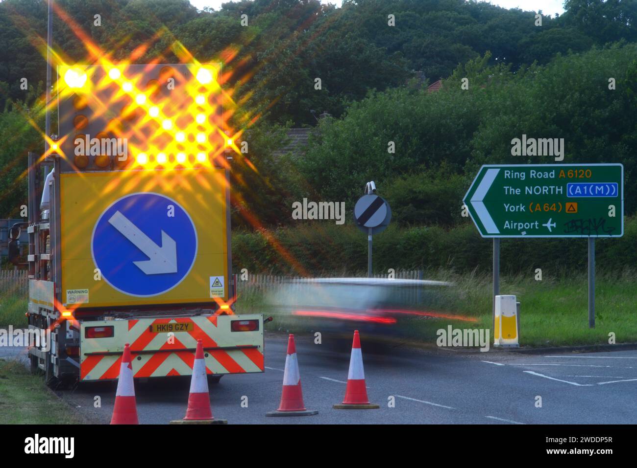 traffic passing flashing warning lights on highway maintenance lorry ... traffic passing flashing warning lights on highway maintenance lorry ...