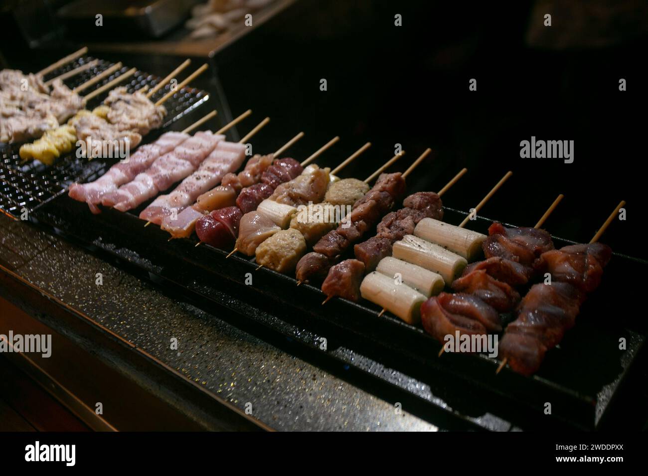 Grilled yakitori chicken skewers at an Izakaya restaurant in Omoide ...