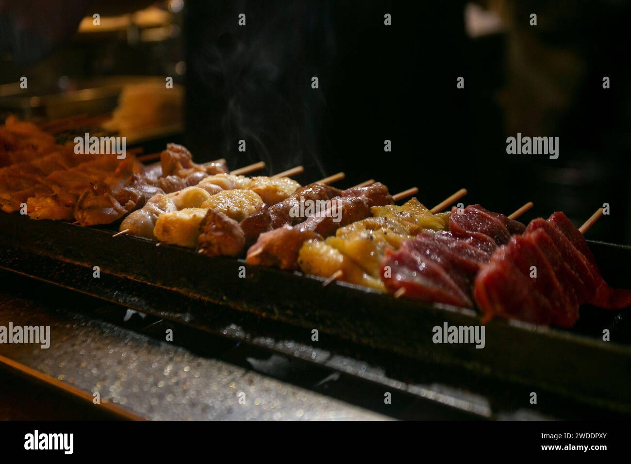 Grilled yakitori chicken skewers at an Izakaya restaurant in Omoide ...