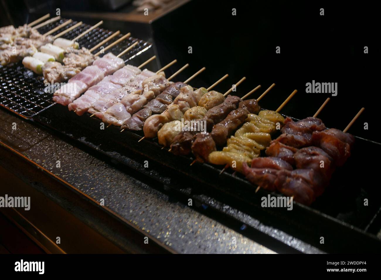 Grilled yakitori chicken skewers at an Izakaya restaurant in Omoide ...
