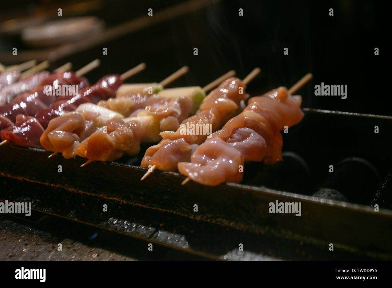 Grilled yakitori chicken skewers at an Izakaya restaurant in Omoide ...