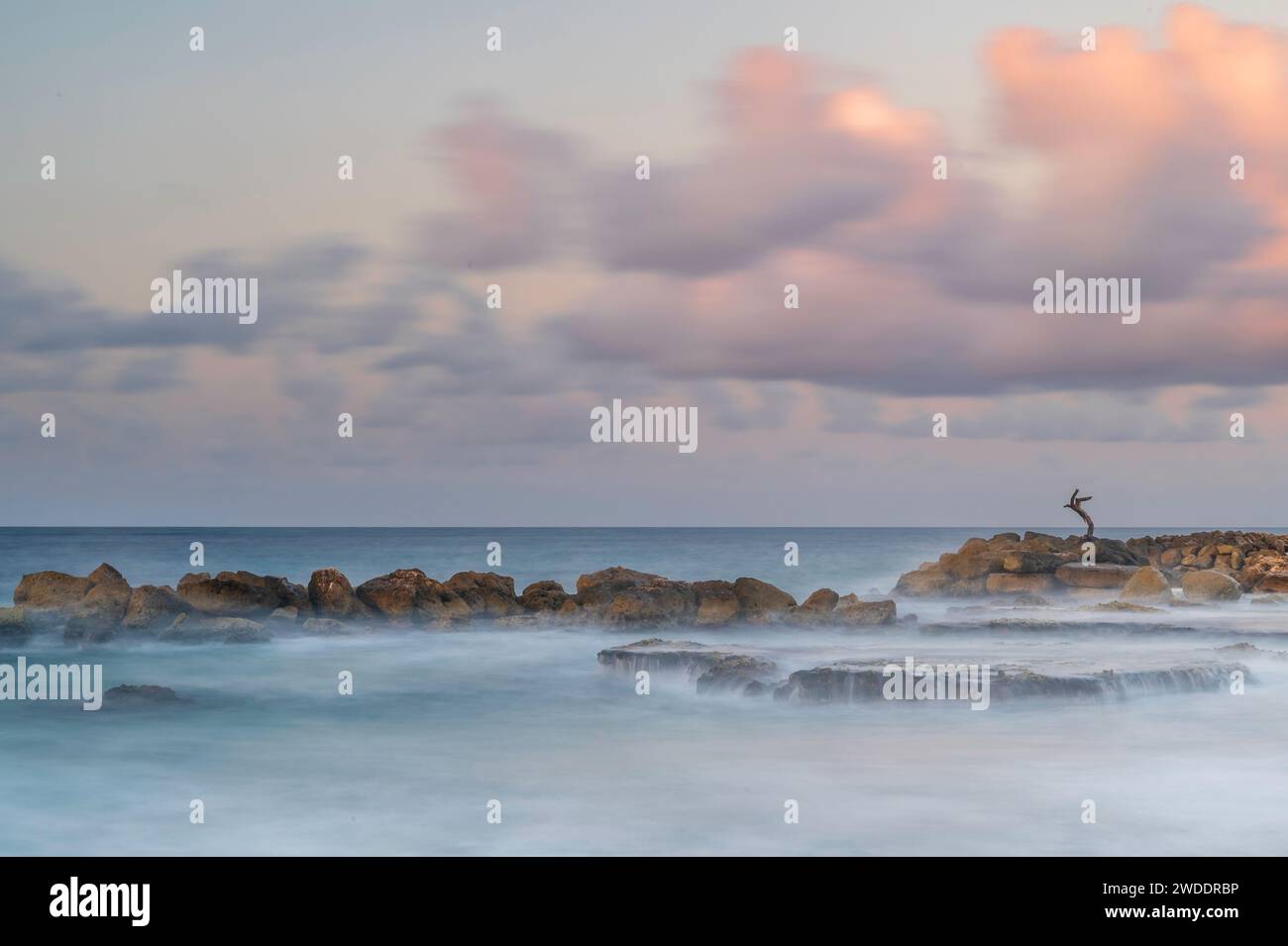 Ocean water, cascading over rocks and reef, on the shoreline of Curacao ...