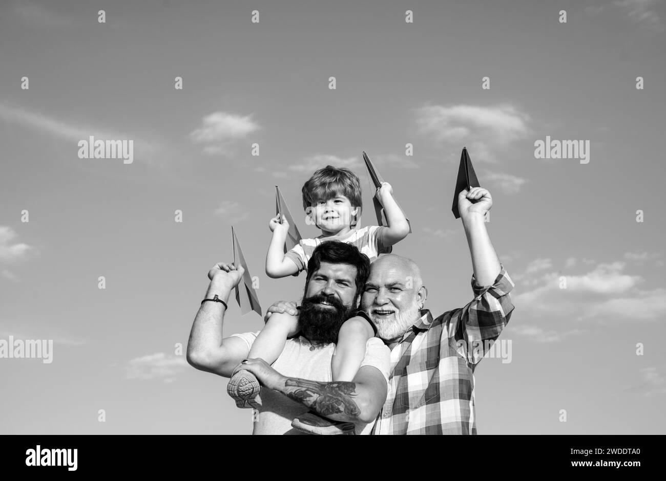Men generation: grandfather father and grandson are hugging looking at ...