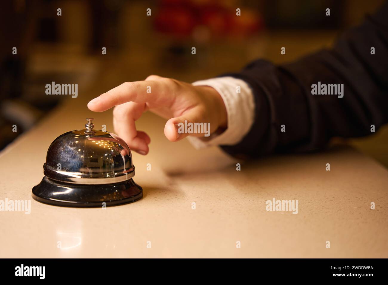 Close up photo of hand ringing bell at reception Stock Photo - Alamy