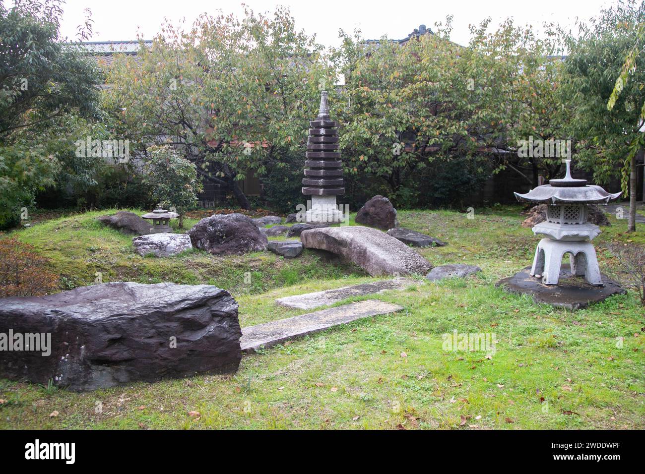 Traditional Japanese garden with a stone sculpture in a traditional tea ...