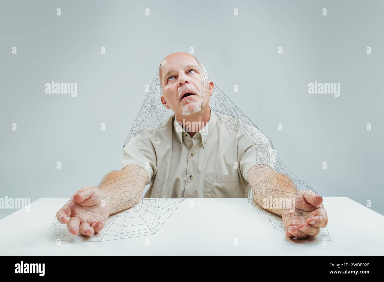 Elderly man sits with cobwebs sprawling from him, symbolizing a ...